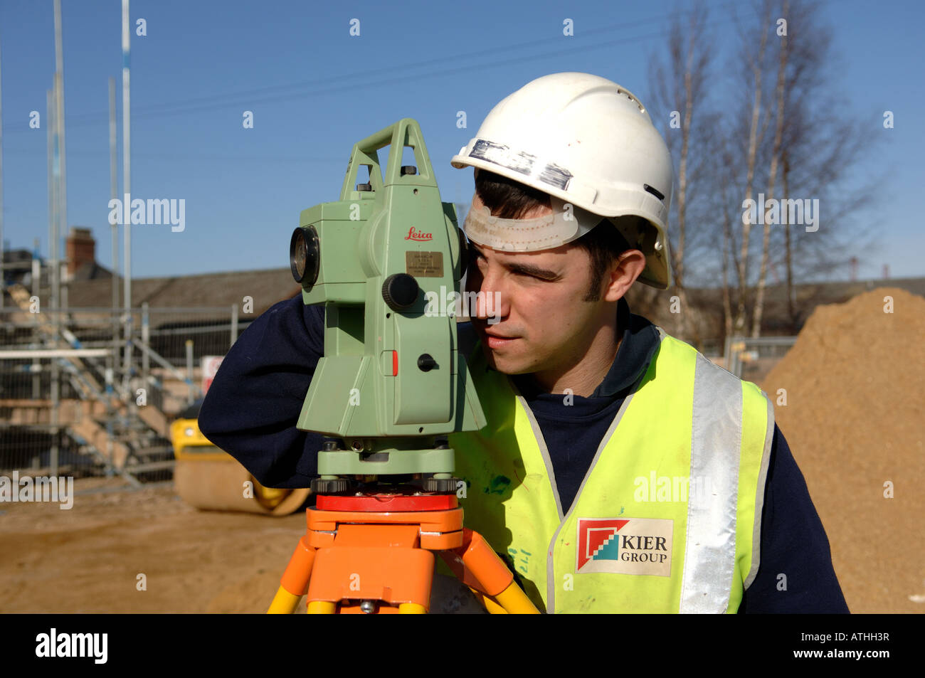 Civil engineer surveying building site using a theodolite Stock Photo ...
