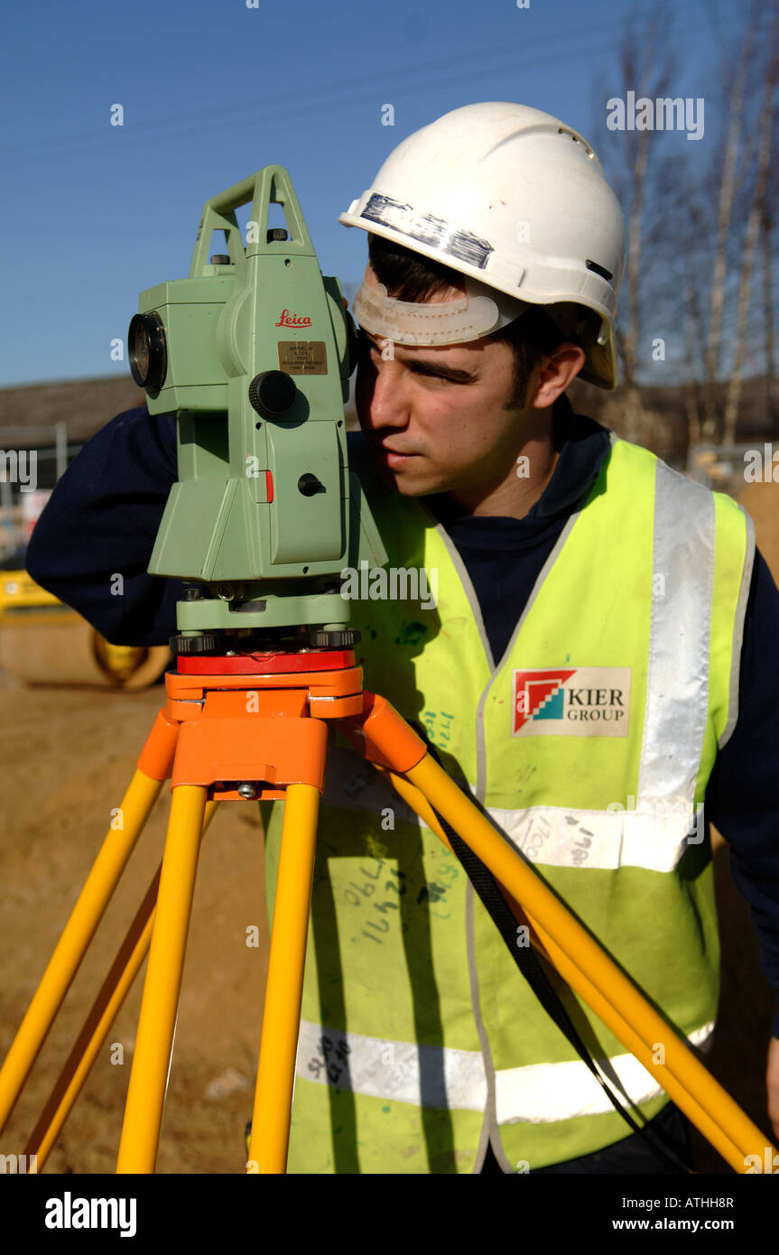 Civil engineer surveying building site using a theodolite Stock Photo ...