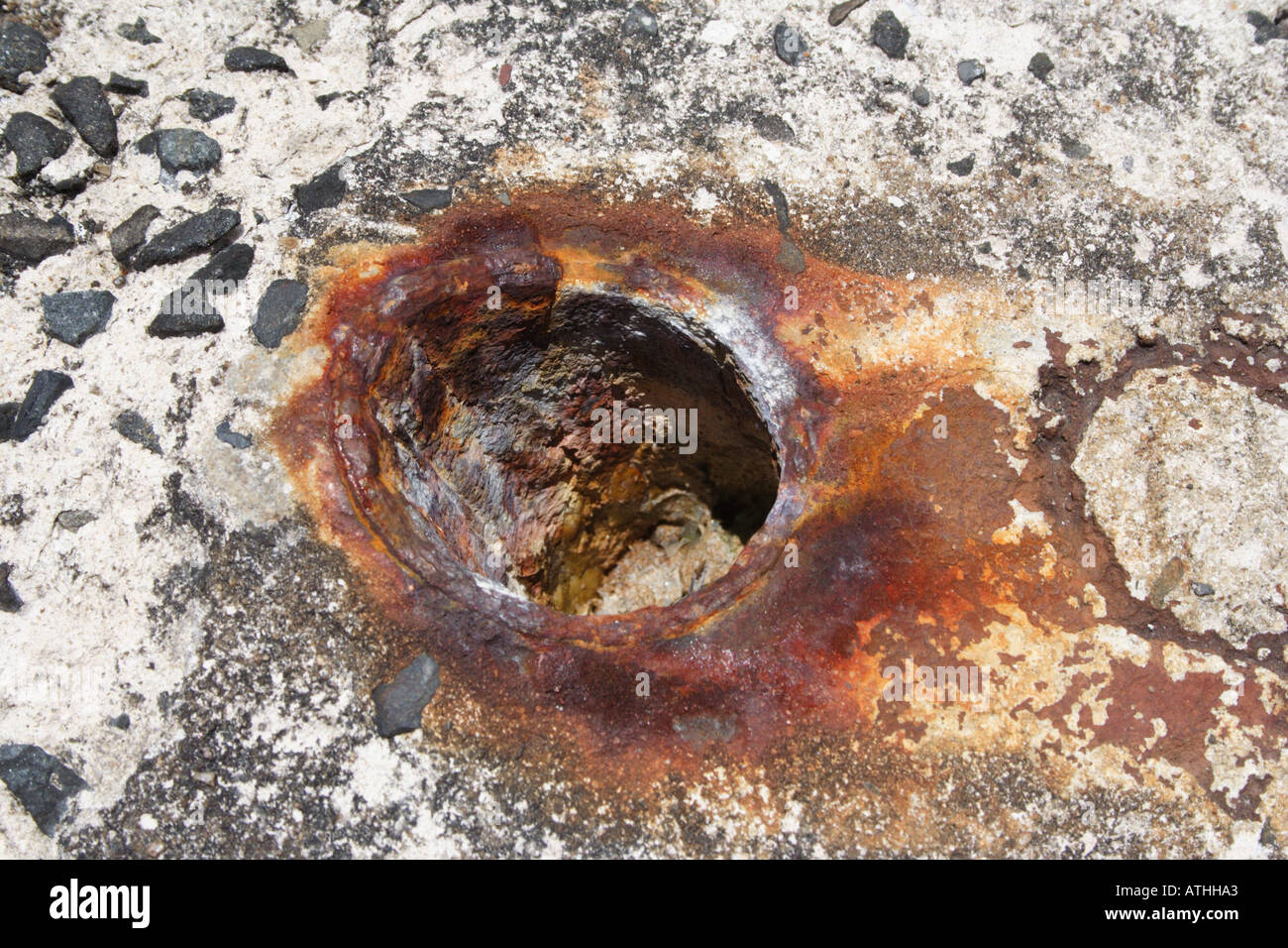 RUSTY HOLE WHERE A POLE USED TO BE Stock Photo - Alamy