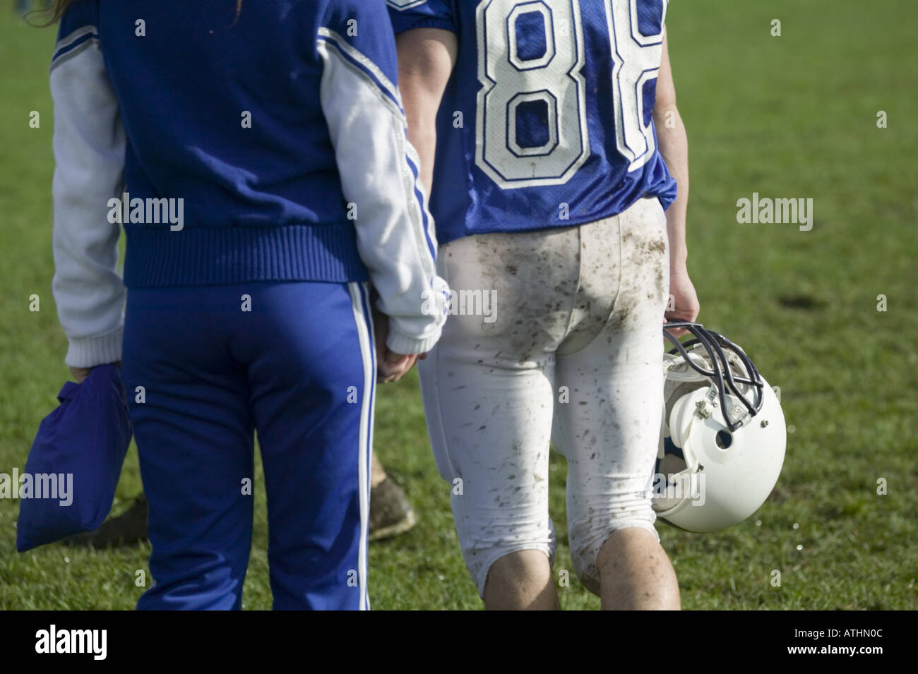 High school football player and girlfriend cheerleader after a muddy ...