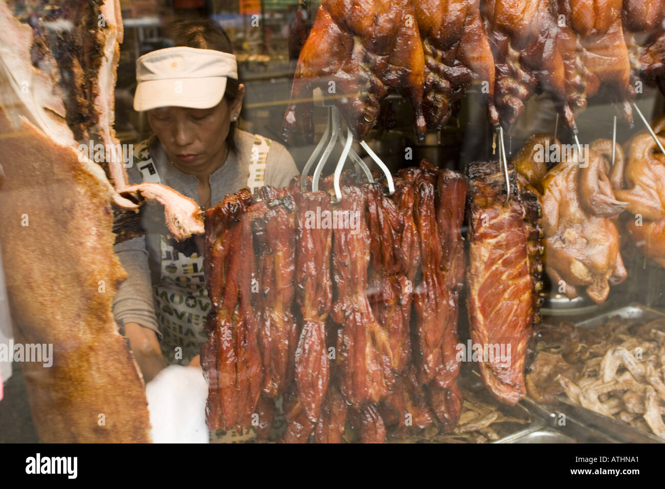 Roast Peking duck and ribs hanging in restaurant window Chinatown NYC ...