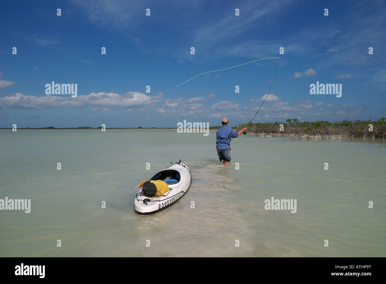 A fly fisherman casts to stealthy bonefish while salt water flats ...