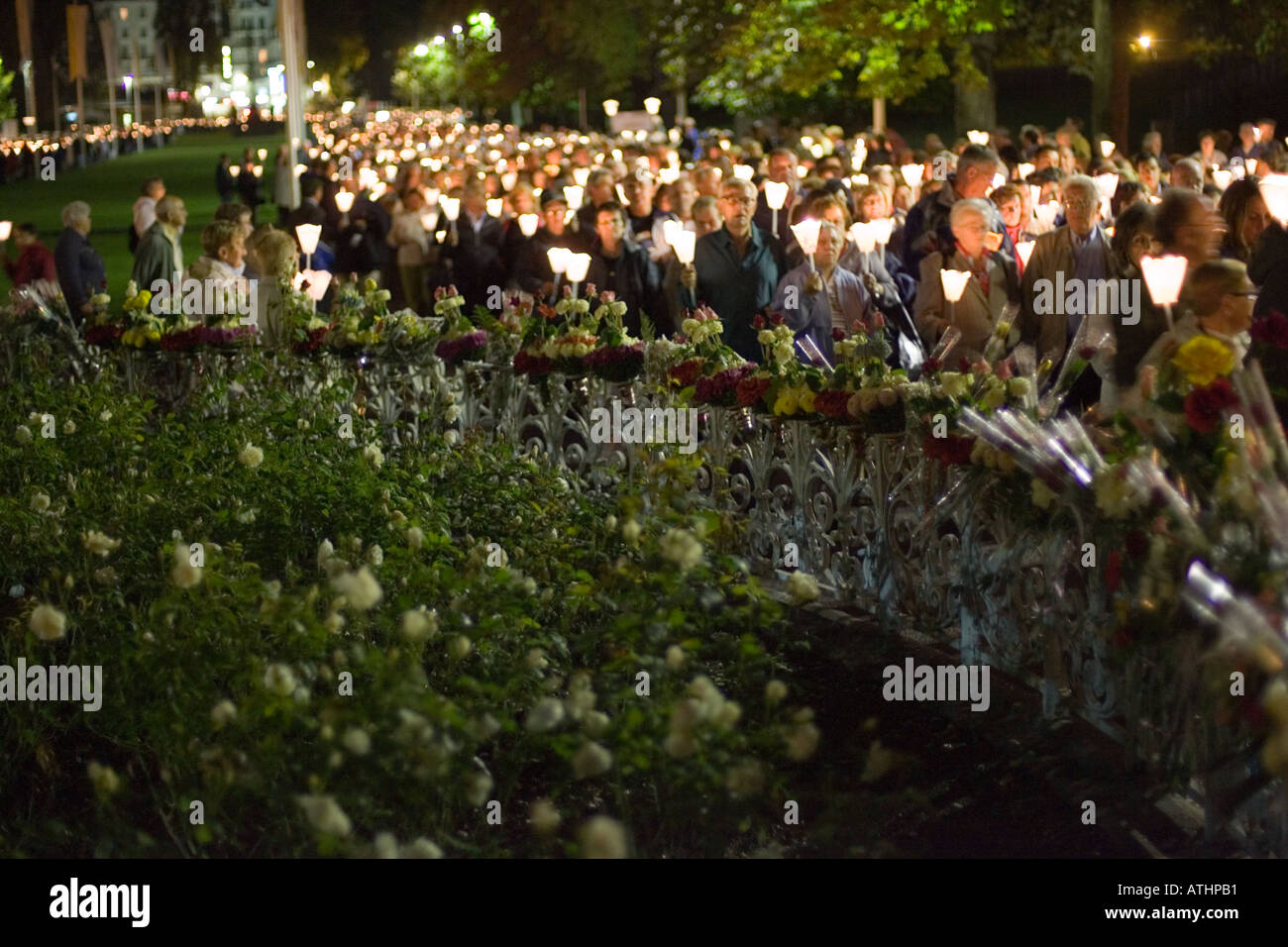 Pilgrims in candlelight procession on rainy evening Lourdes France ...