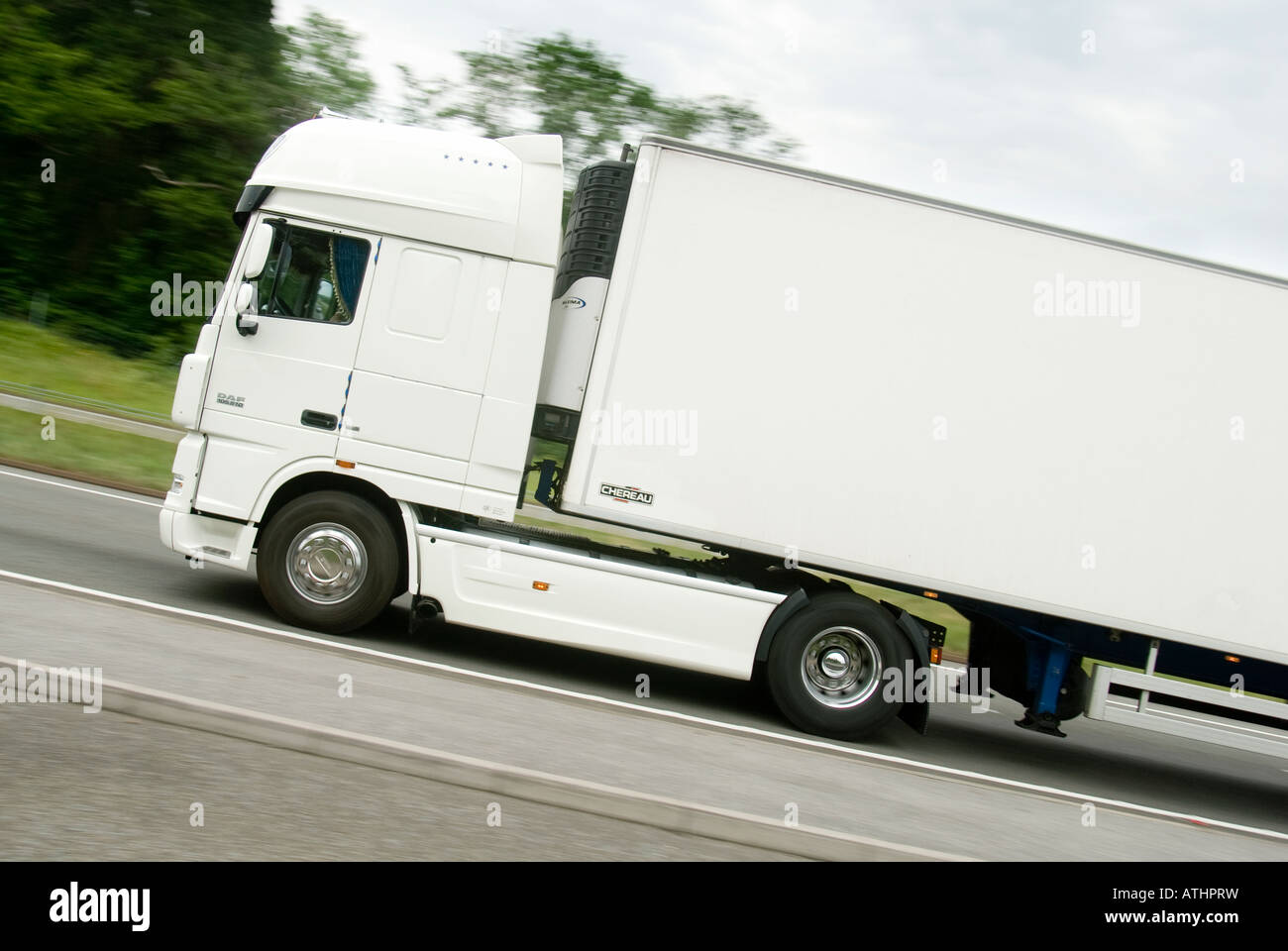 white daf lorry speeding along a road in the uk Stock Photo - Alamy