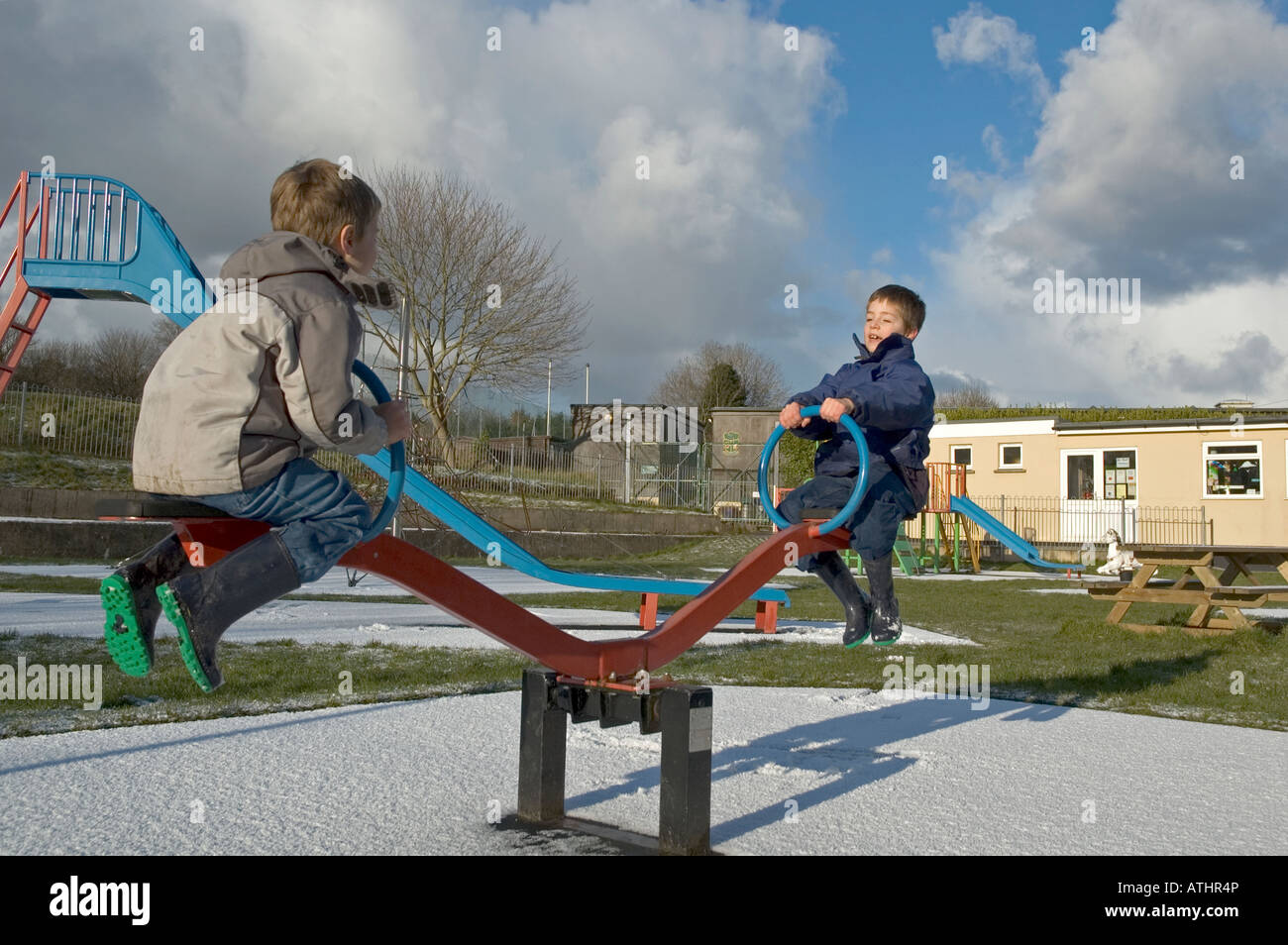 two little boys at the park playing on the seesaw Stock Photo - Alamy