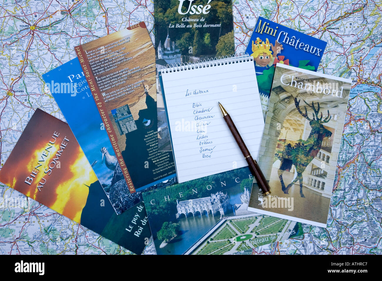 Brochures and notebook spread out on map of France Stock Photo - Alamy