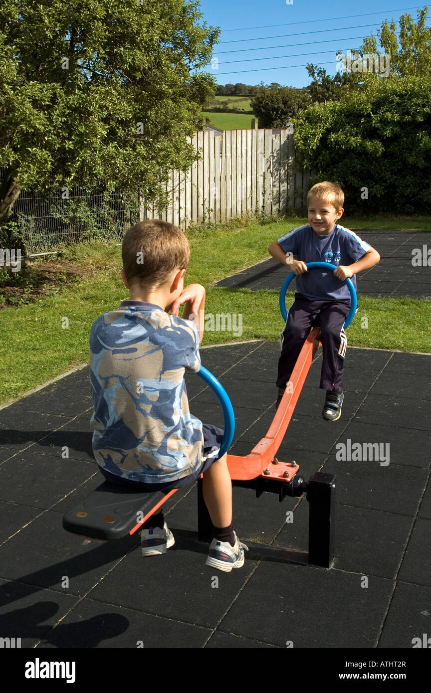 Children playing on seesaw hi-res stock photography and images - Alamy