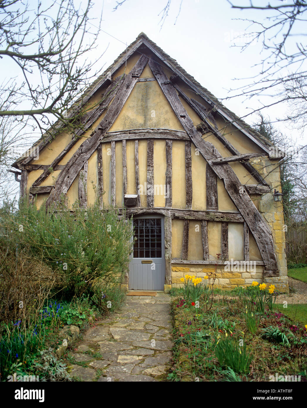 Crucks made from tree trunks in the end wall of a half timbered cottage ...