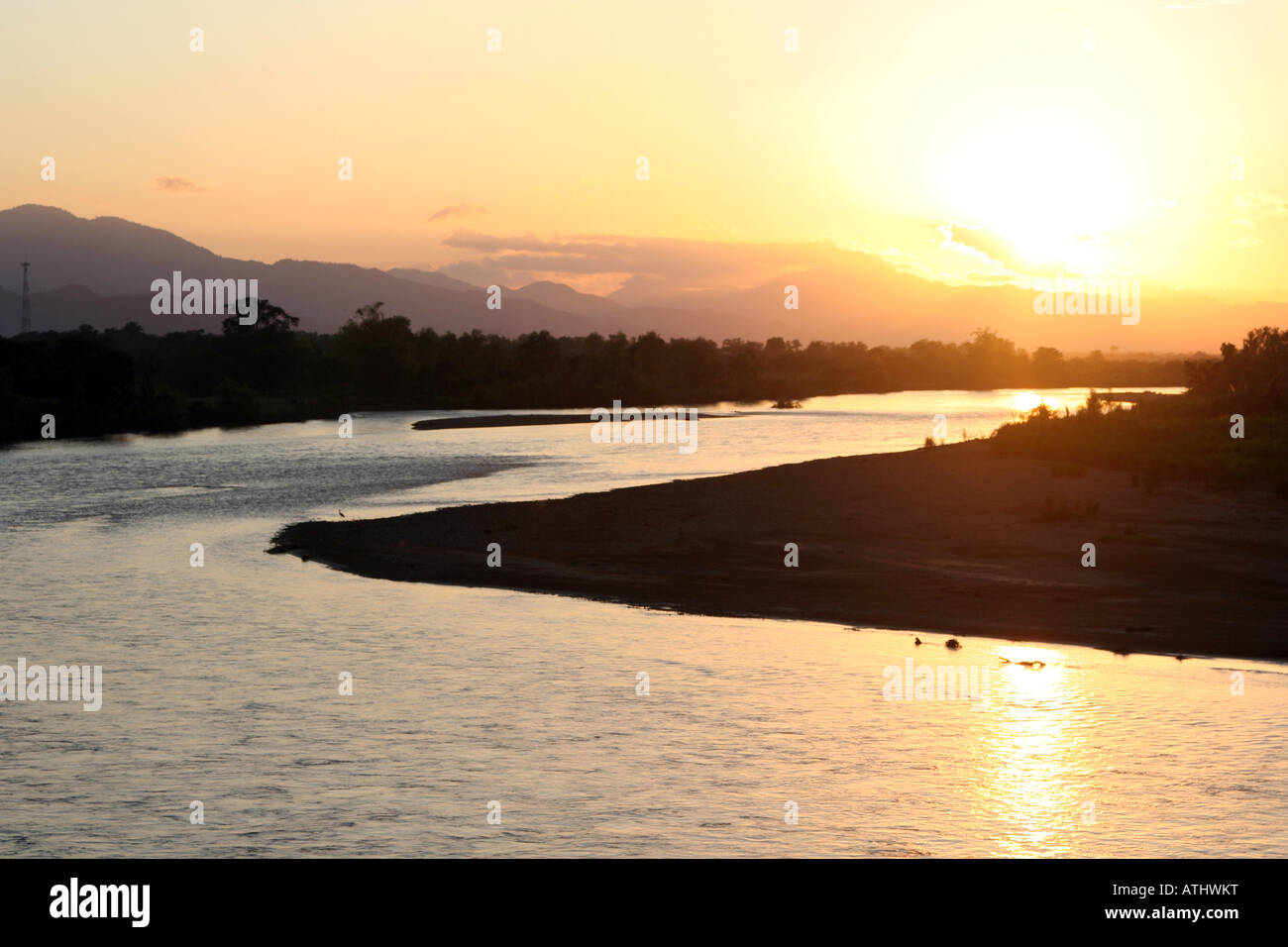 The sun sets over a small river running from Olancho to the Caribbean ...
