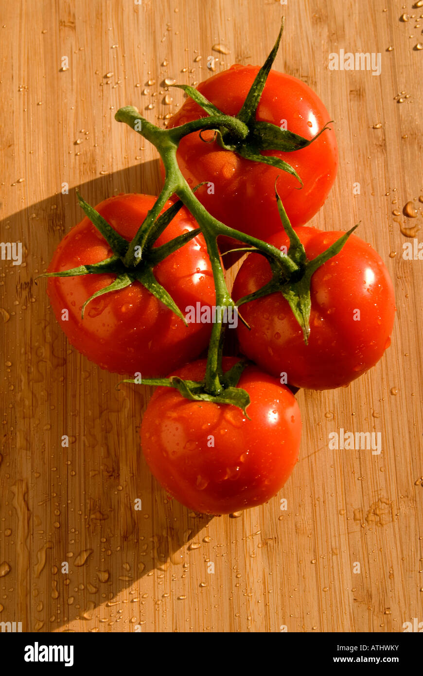 Tomatoes attached to the vine hi-res stock photography and images - Alamy
