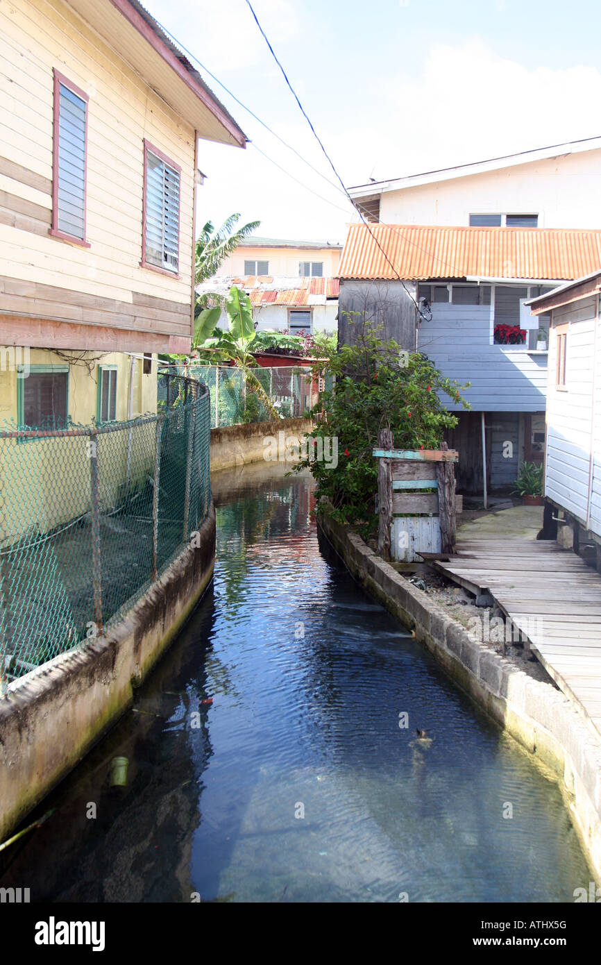 A canal runs through the birghtly colored homes of Bonacca Caye on the ...