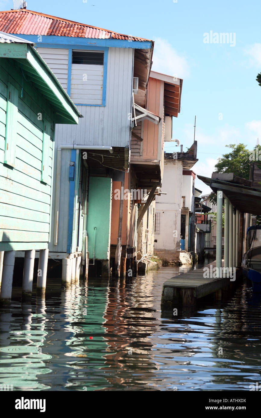 A canal runs through the birghtly colored homes of Bonacca Caye on the ...