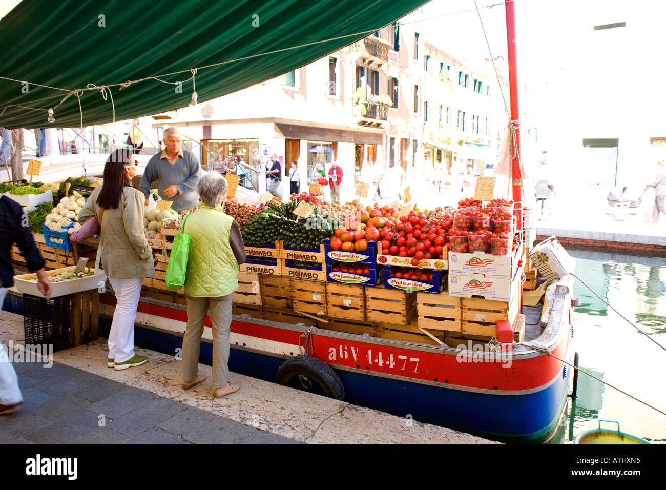 Market stall on a boat on a canal in Venice Italy Stock Photo - Alamy
