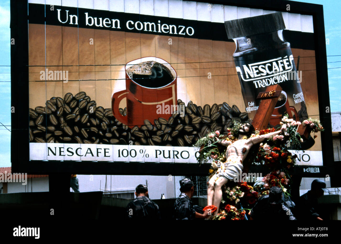 Figure of Jesus carried past billboard in Ecuador Stock Photo - Alamy