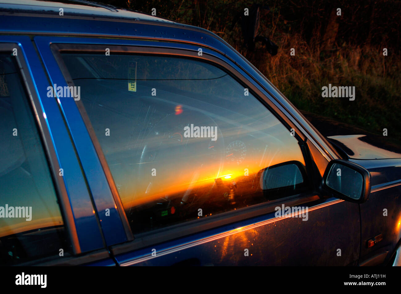 Sunset Reflecting In The Side Of A Car Stock Photo - Alamy