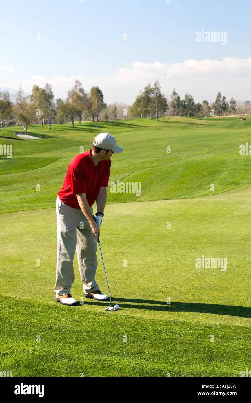 Golfers and a resort golf course in action Stock Photo - Alamy