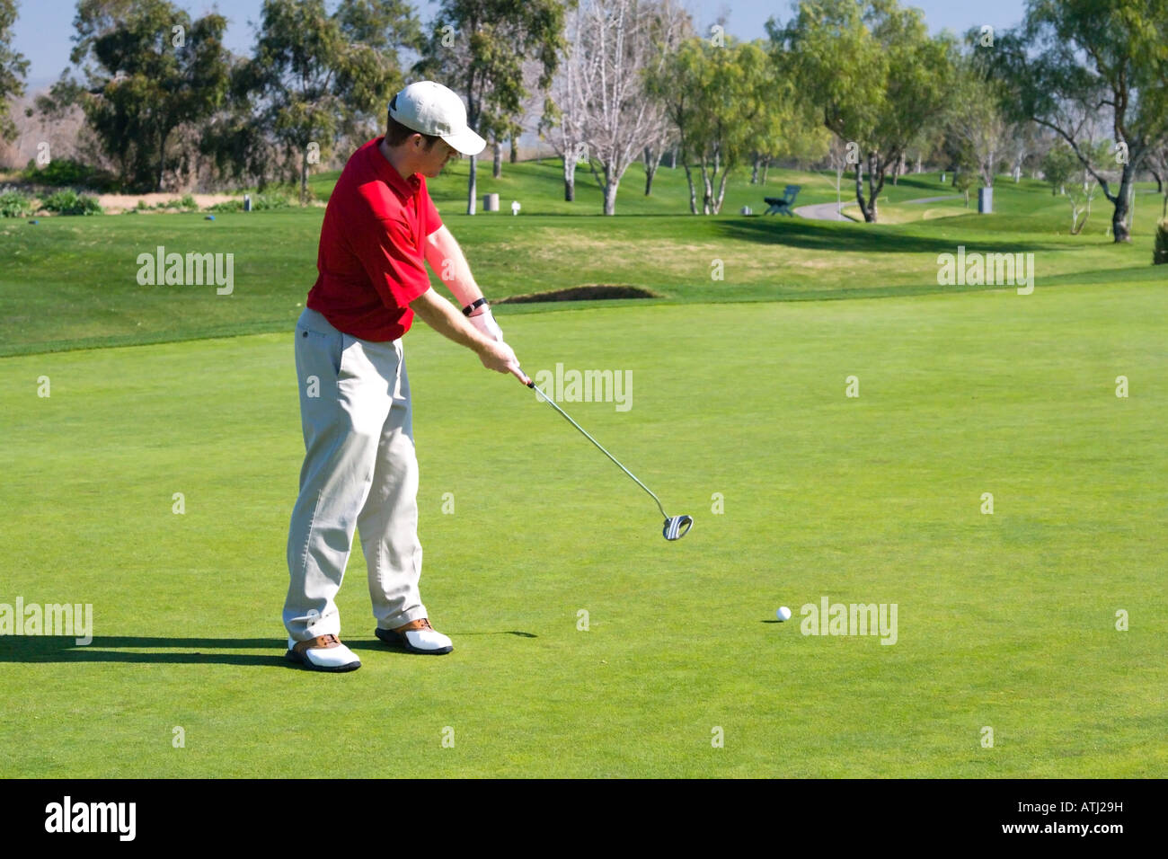 Golfers and a resort golf course in action Stock Photo - Alamy