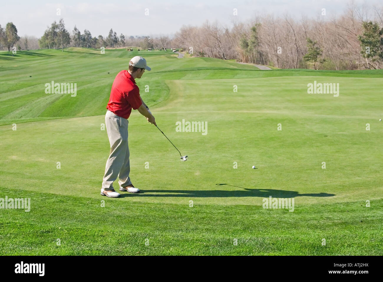 Golfers and golf course action in the morning Stock Photo - Alamy