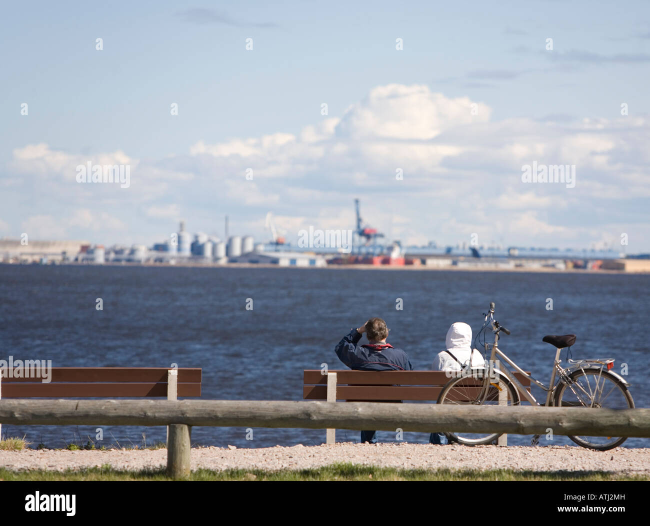 A couple sitting on a bench at seashore Finland Stock Photo - Alamy