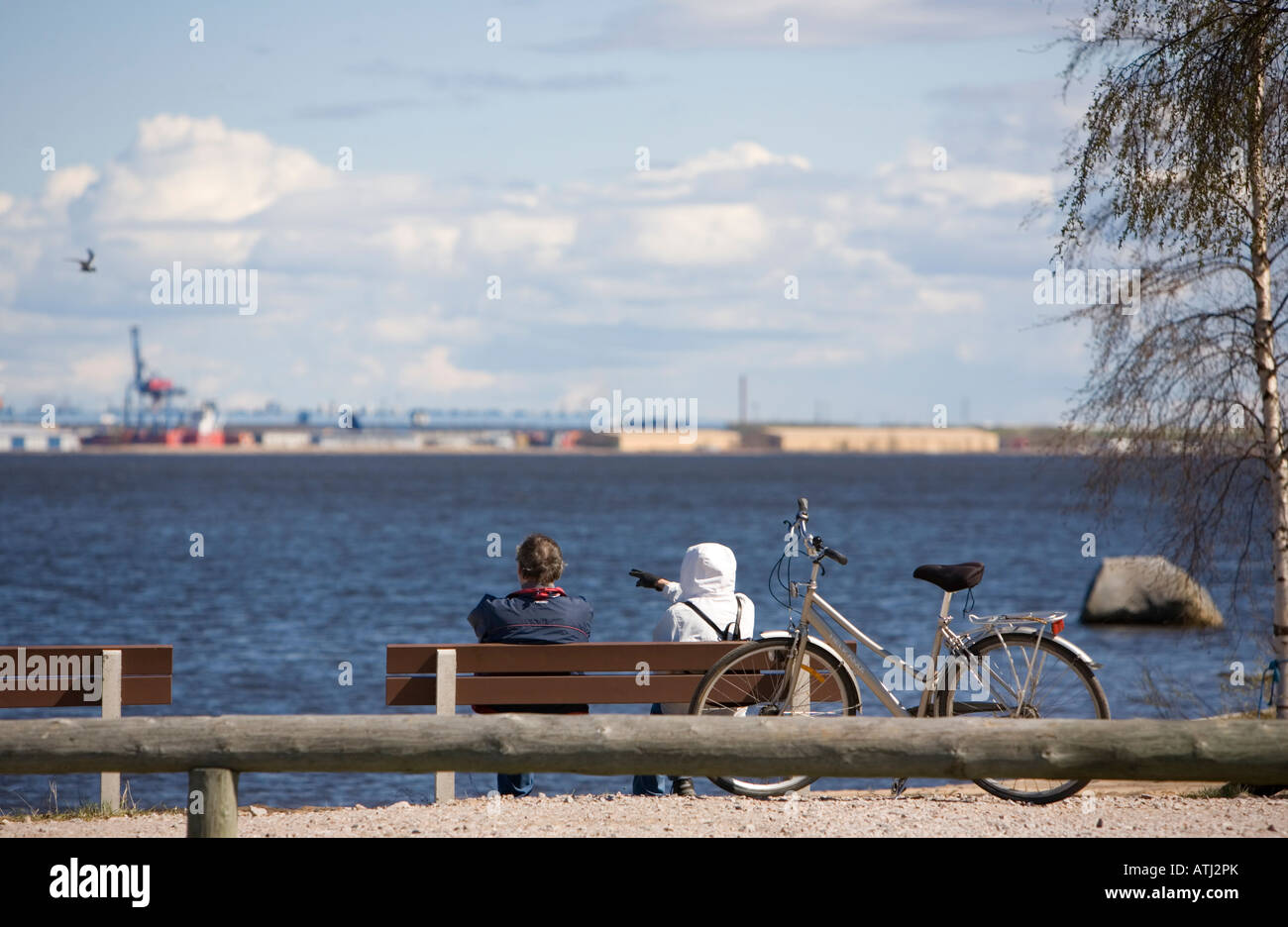 A couple sitting on a bench at seashore Finland Stock Photo - Alamy