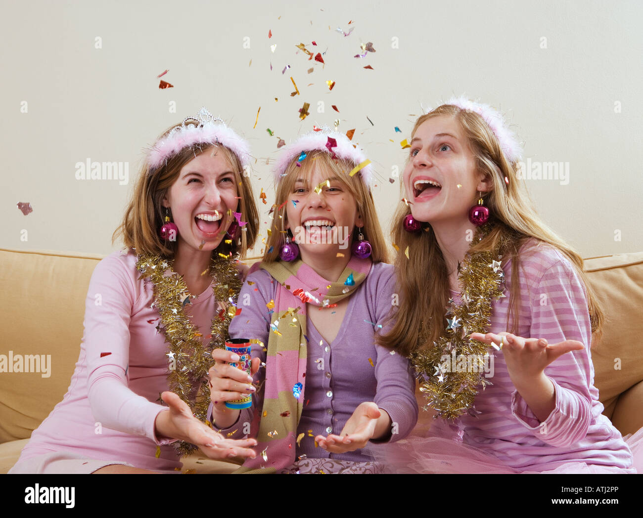 three teenage girls popping party popper Stock Photo - Alamy