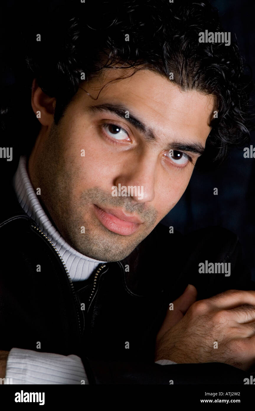 man folding his arms on a black background Stock Photo - Alamy