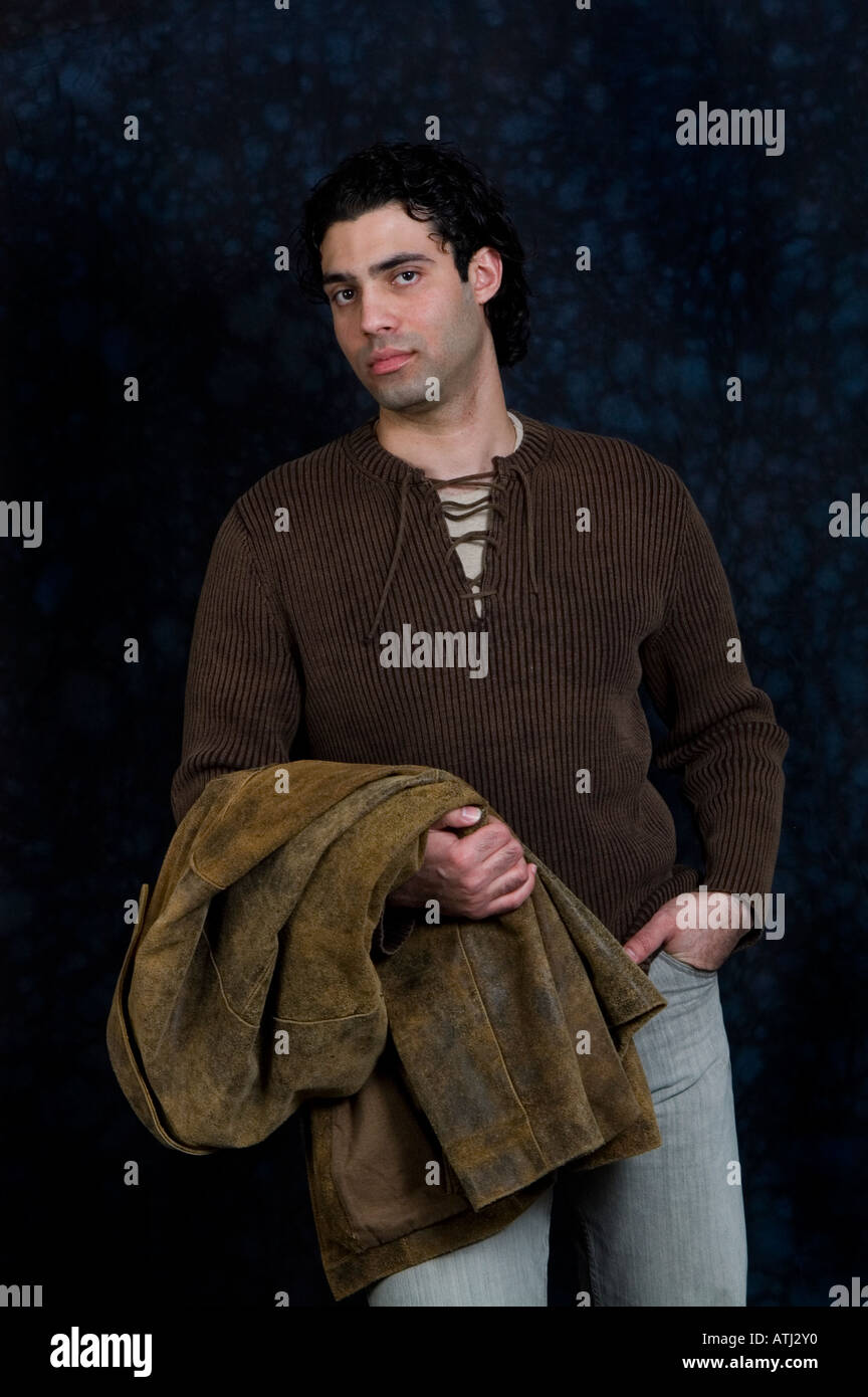 one man posing and holding his jacket Stock Photo - Alamy