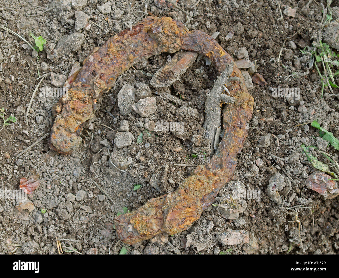 old rusty horseshoe as symbol for luck lying on ground Stock Photo - Alamy