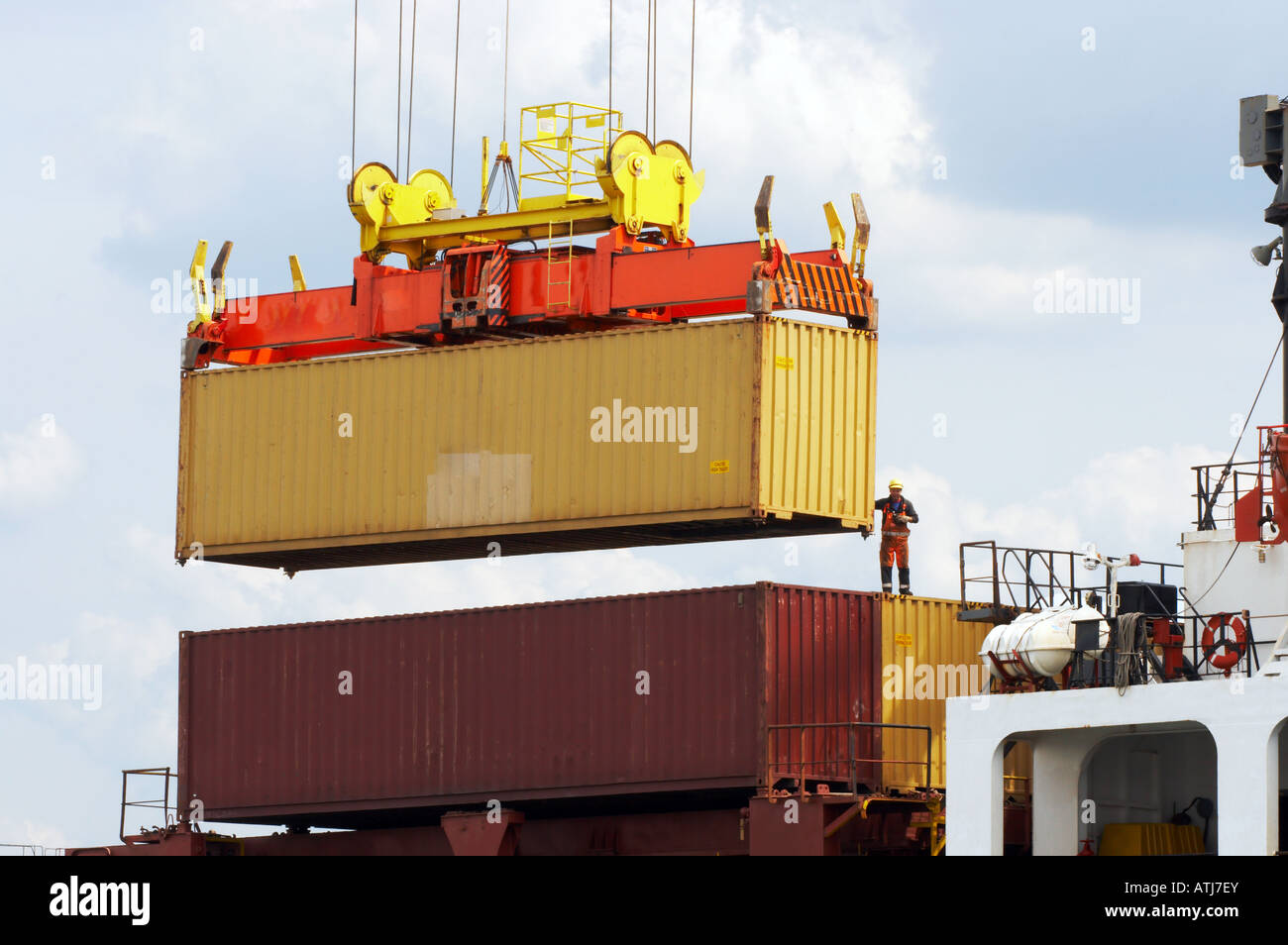 Dockworker checking the precise placement of a container Stock Photo ...