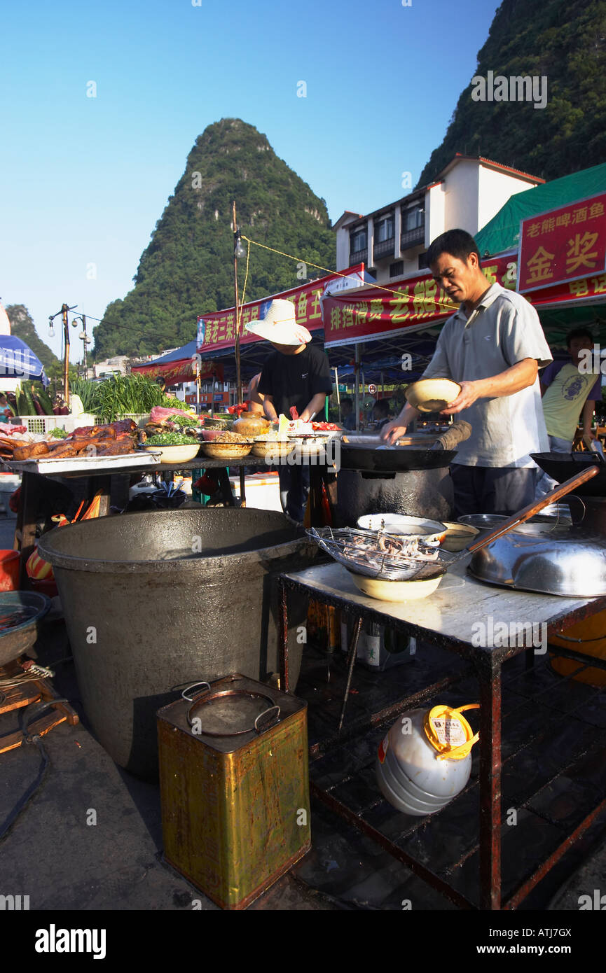 Man Cooking At Market Stall, Yangshuo Stock Photo - Alamy