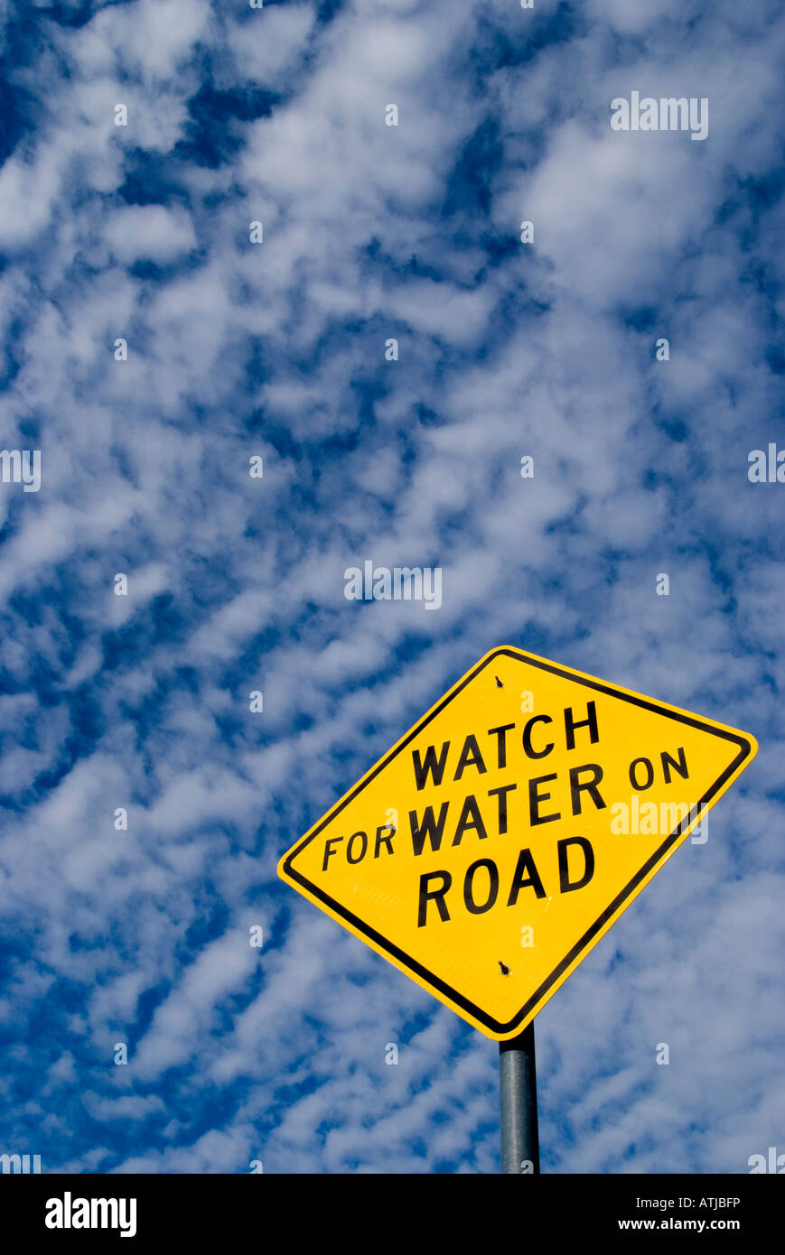 "Water on Road" sign Stock Photo - Alamy