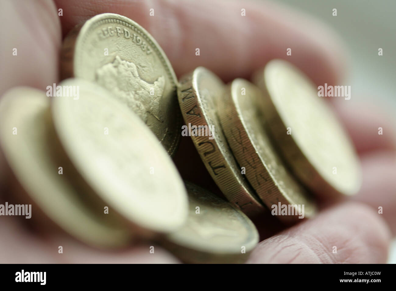 Close up of hand holding pound coins Stock Photo - Alamy
