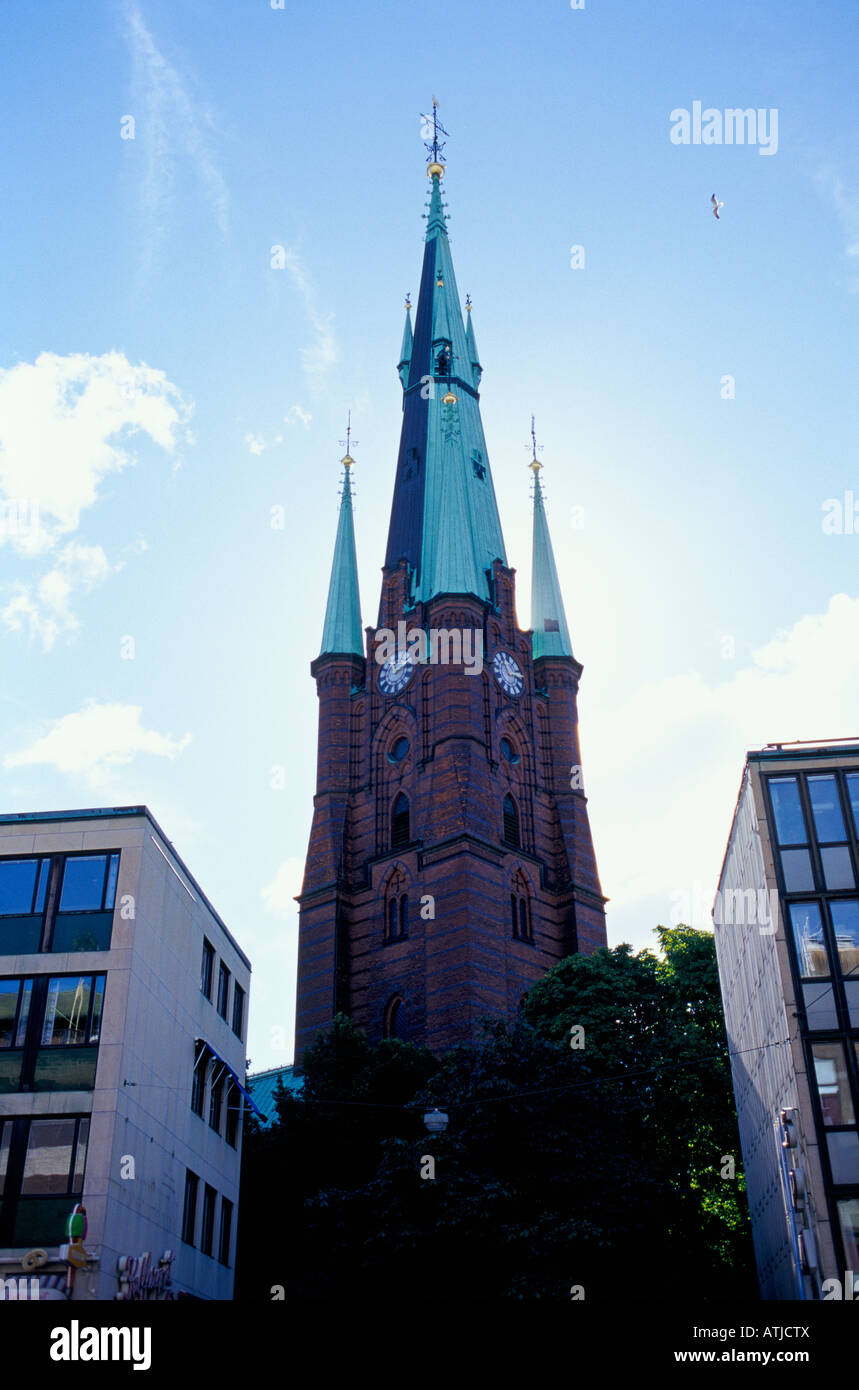 Church spire with copper roof between two modern buildings Stock Photo ...