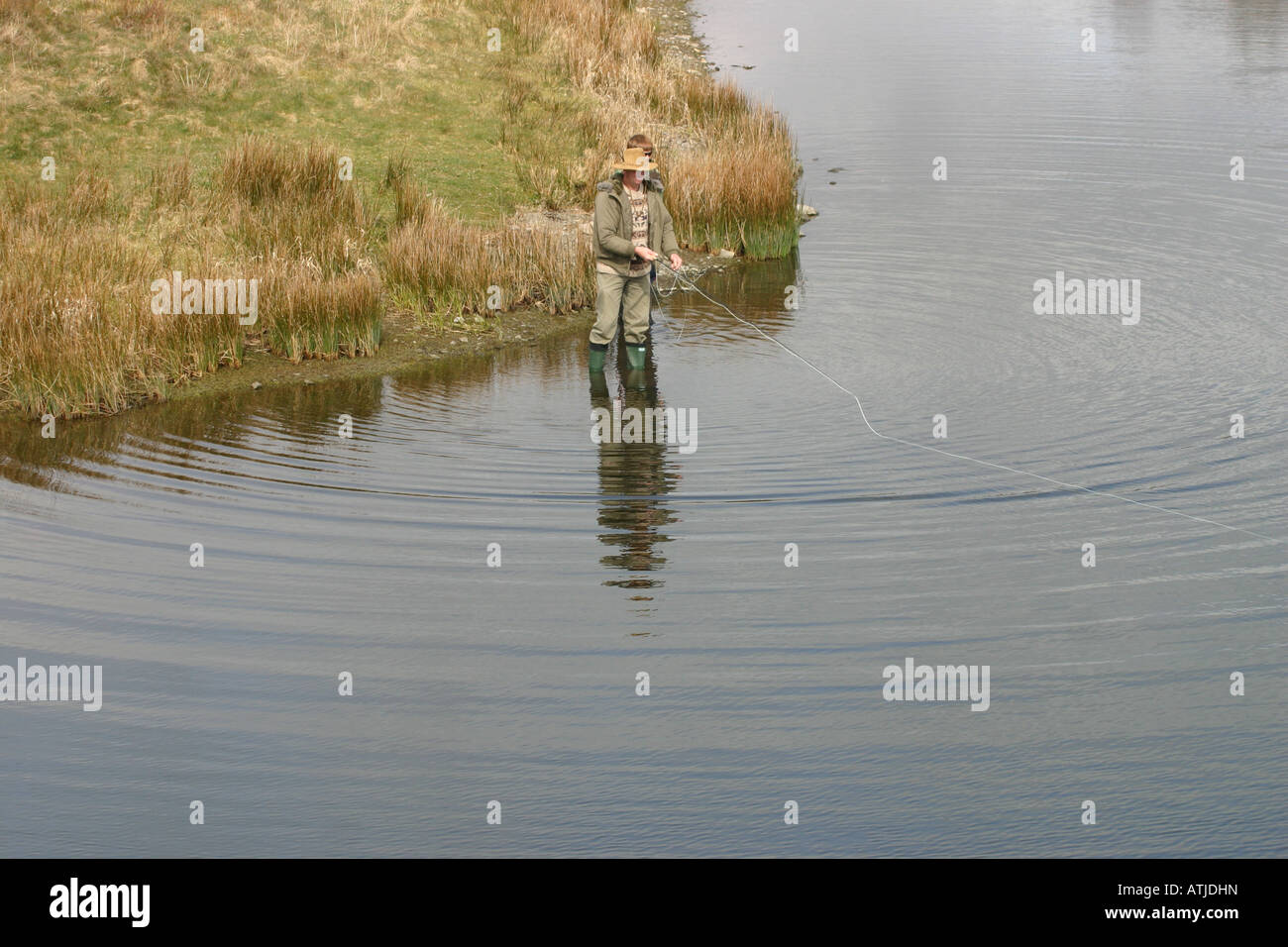 fisherman ripples reservoir bank fishing rod line Stock Photo - Alamy