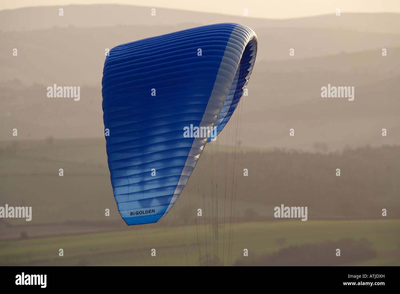 Paraglider wing in evening sunlight with Welsh Hills in background ...