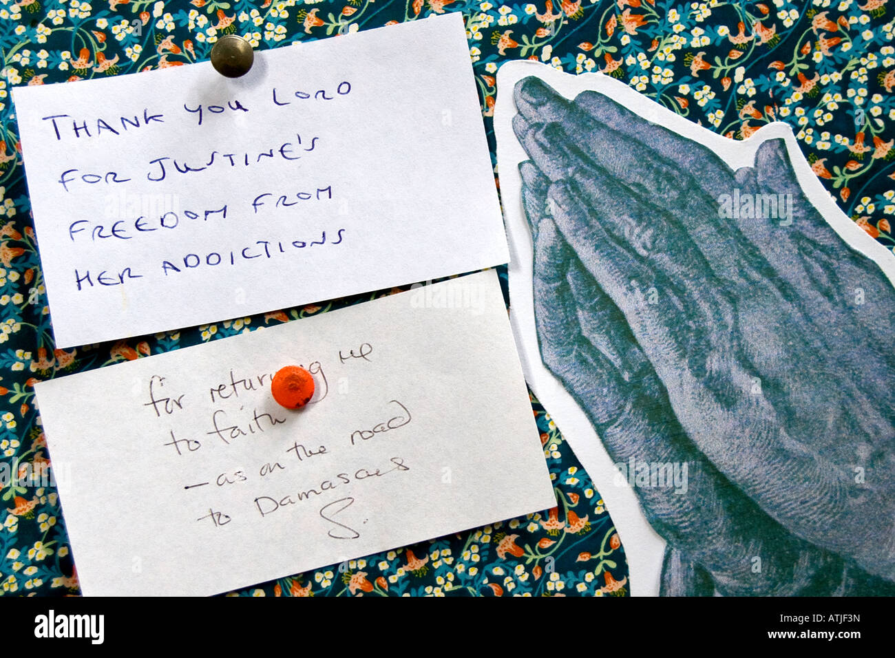 a couple of prayers posted on church noticeboard, with praying hands ...