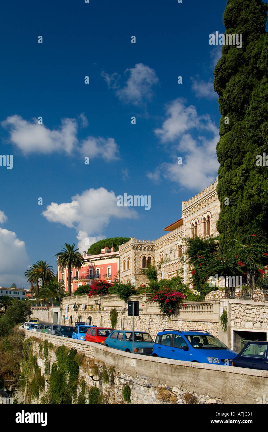 A cliffside road with grand houses and mature pines in the popular ...