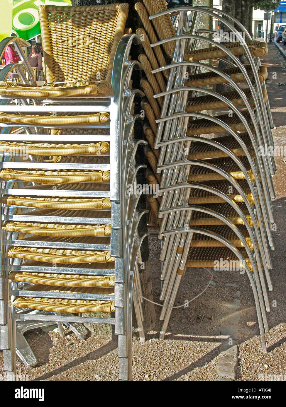 piles of chairs of outdoor cafe restaurant waiting for season Stock ...