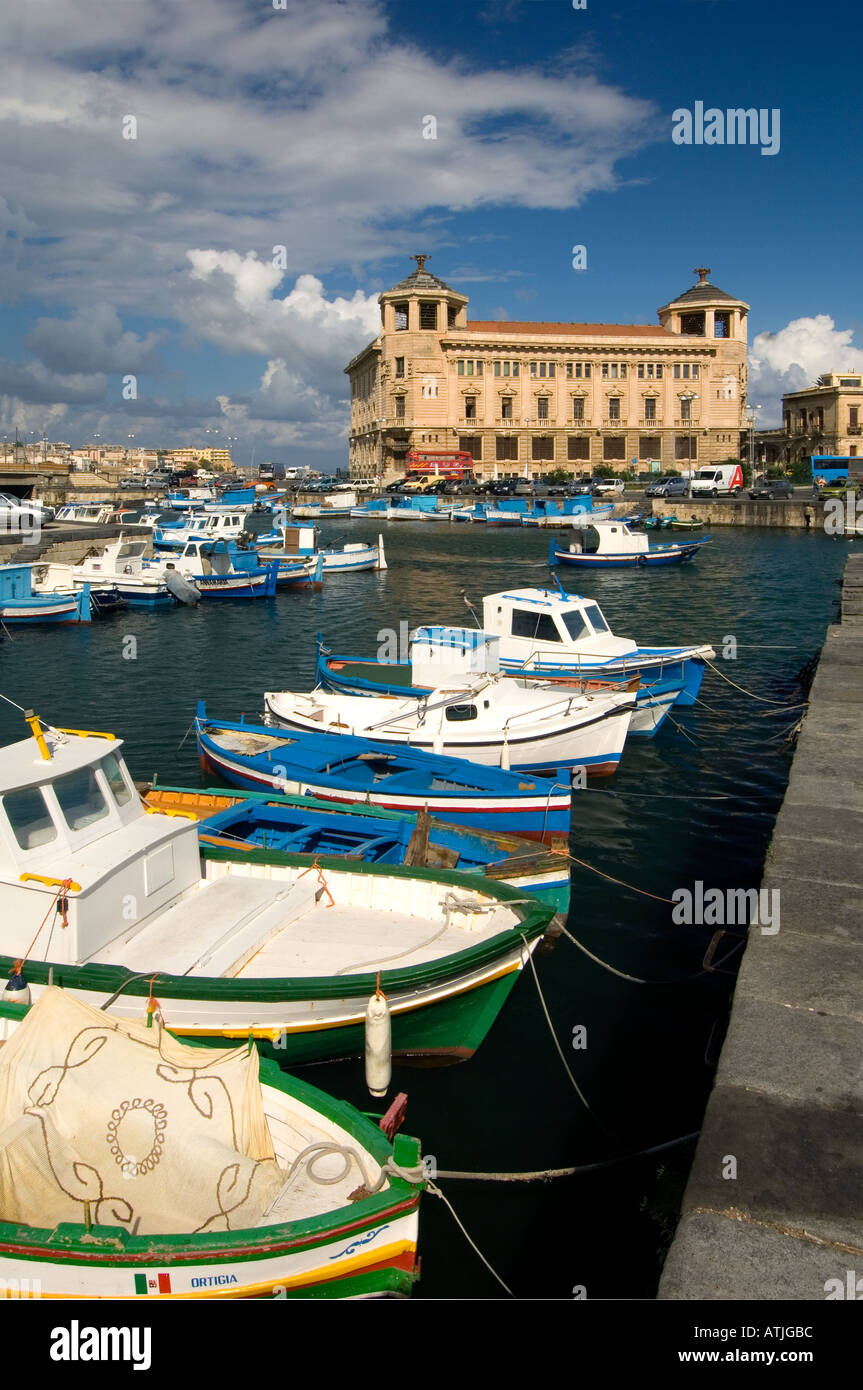 Little boats in a sheltered harbour with the ornate post office ...