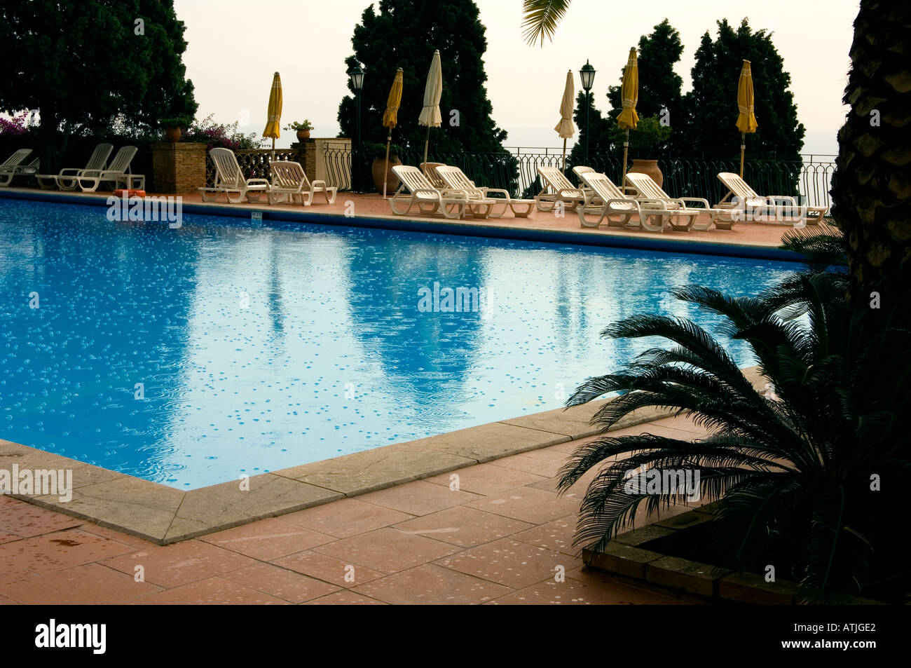 Raindrops falling on the surface of a swimming pool Stock Photo - Alamy