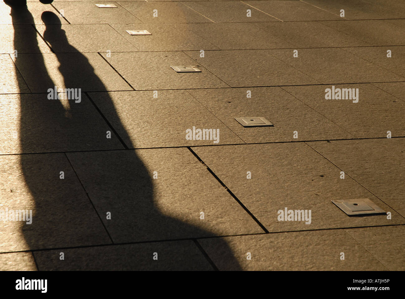 shadow of man walking at sunset Stock Photo - Alamy