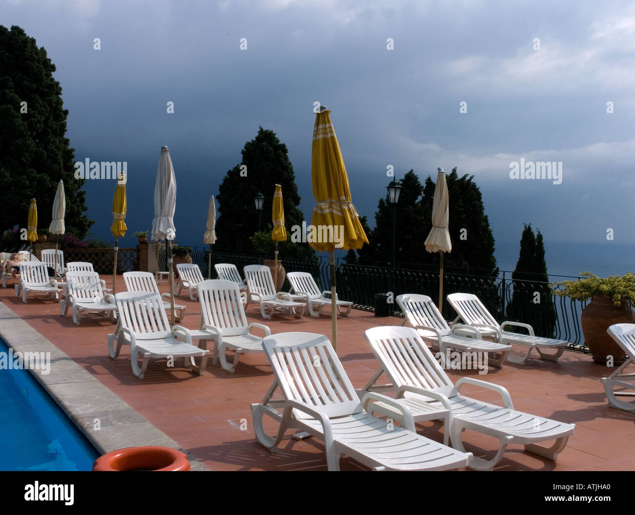 A thunderstorm approaching over a swimming pool of a tourist hotel in ...