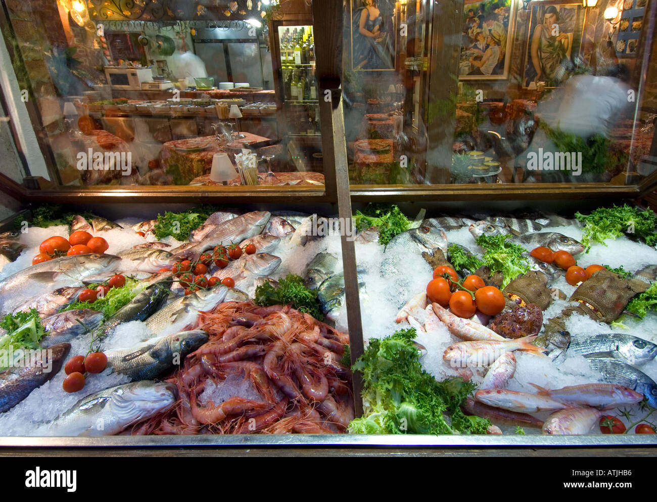 A seafood restaurant displays its wares in a cabinet of crushed ice to ...
