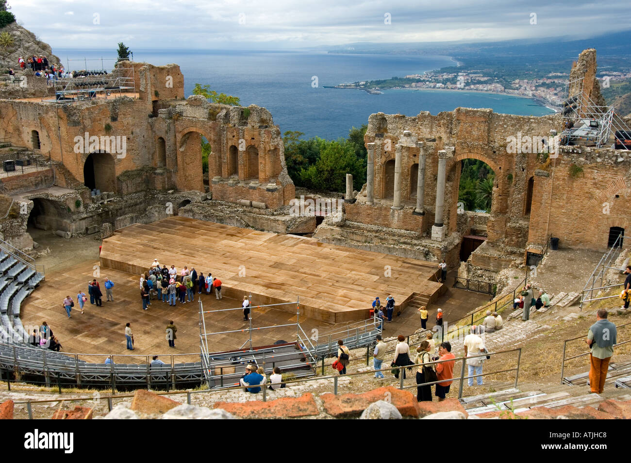 The Greek amphitheatre in Taormina Sicily with the coast of Naxos ...