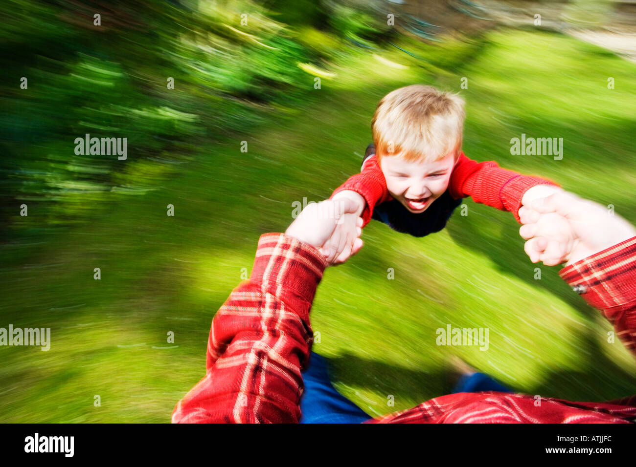 Young boy 3 years old being spun around by dad Stock Photo - Alamy
