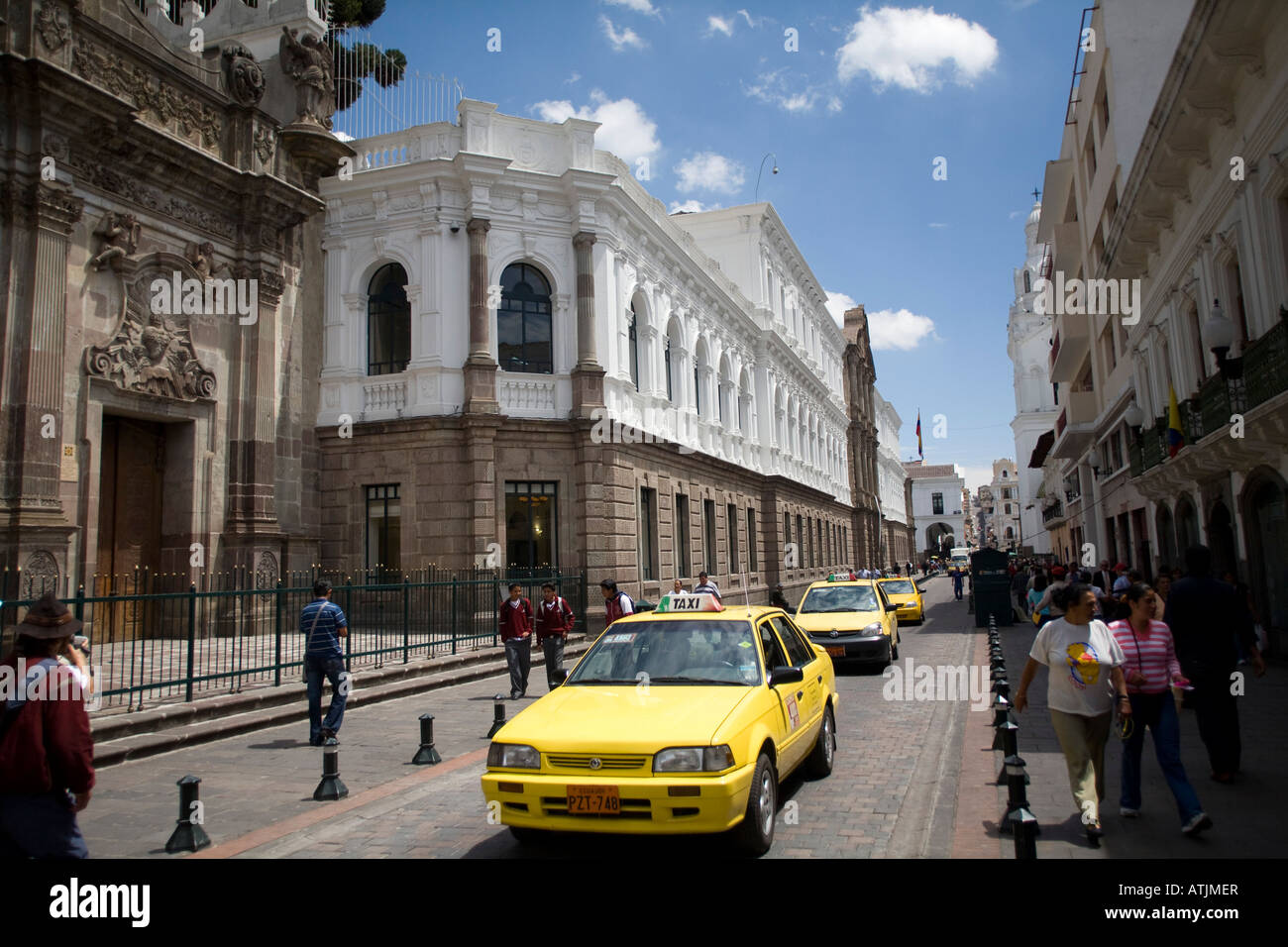 Yellow taxi in Commercial street, buildings in old colonial style ...