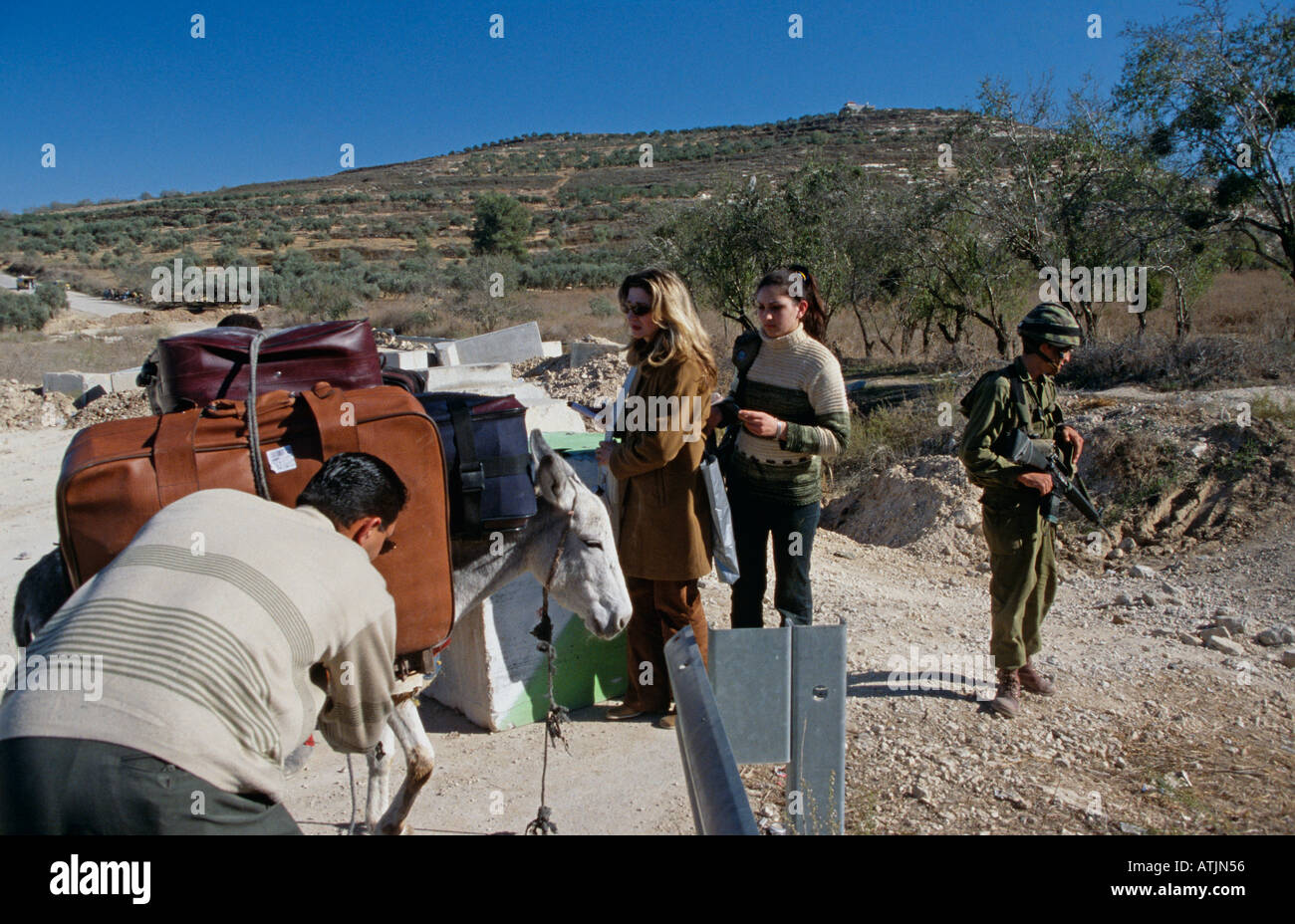 Western tourists with donkey overloaded with luggages and soldier on ...