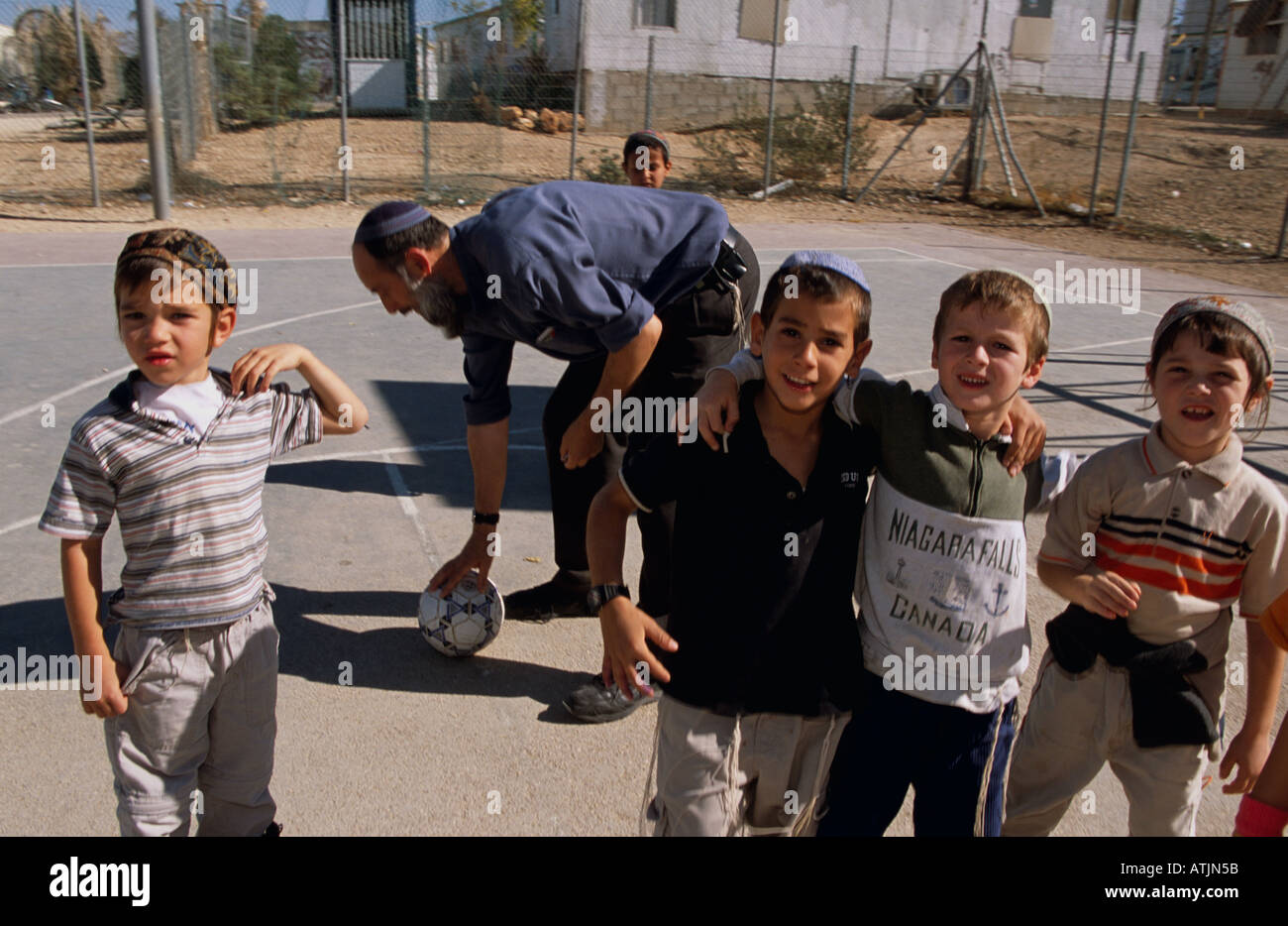 Jewish children playing soccer, coach in background, Jericho, Palestine ...