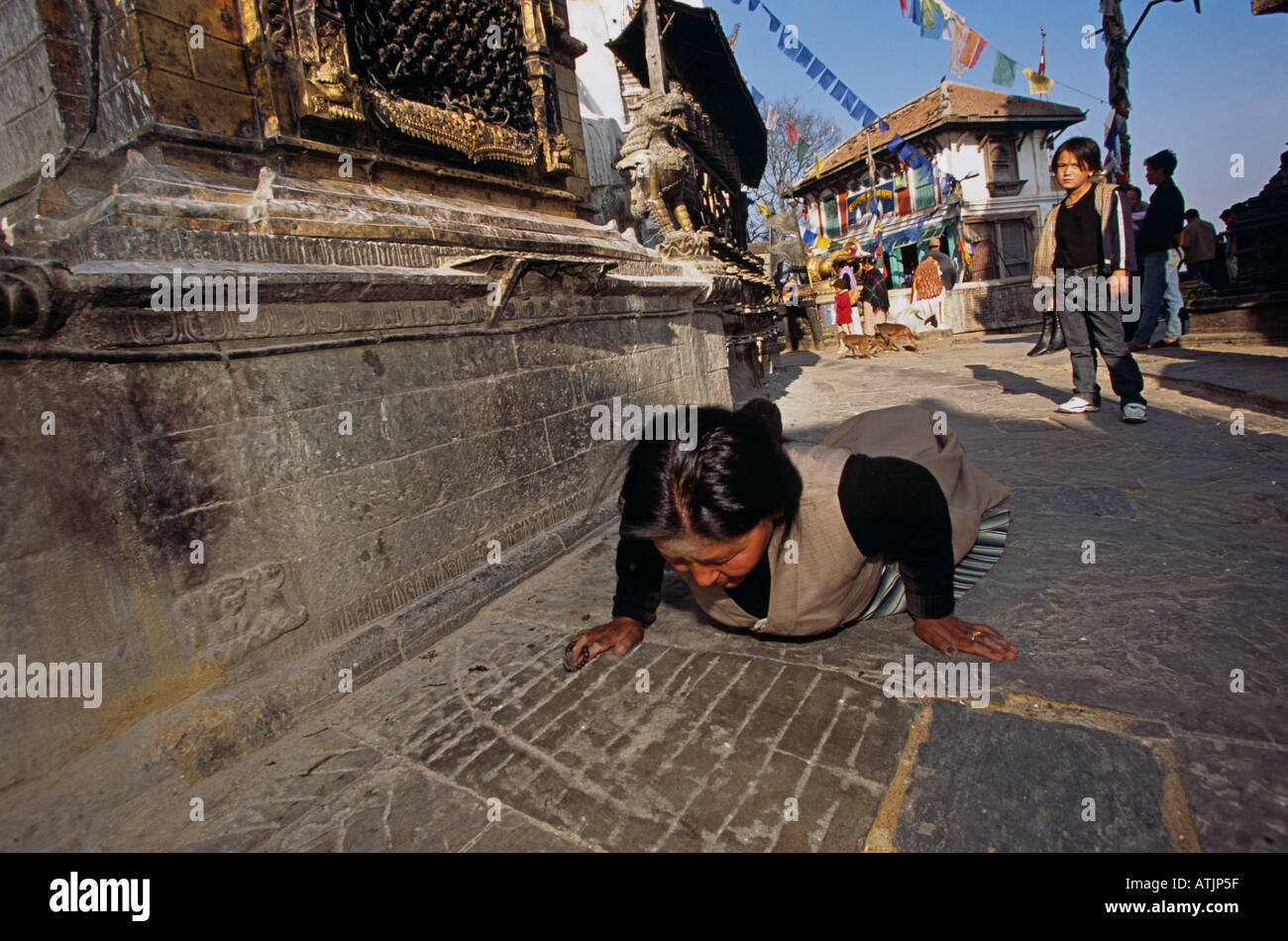 Woman prostrating at Monkey Temple, Kathmandu, Nepal Stock Photo - Alamy