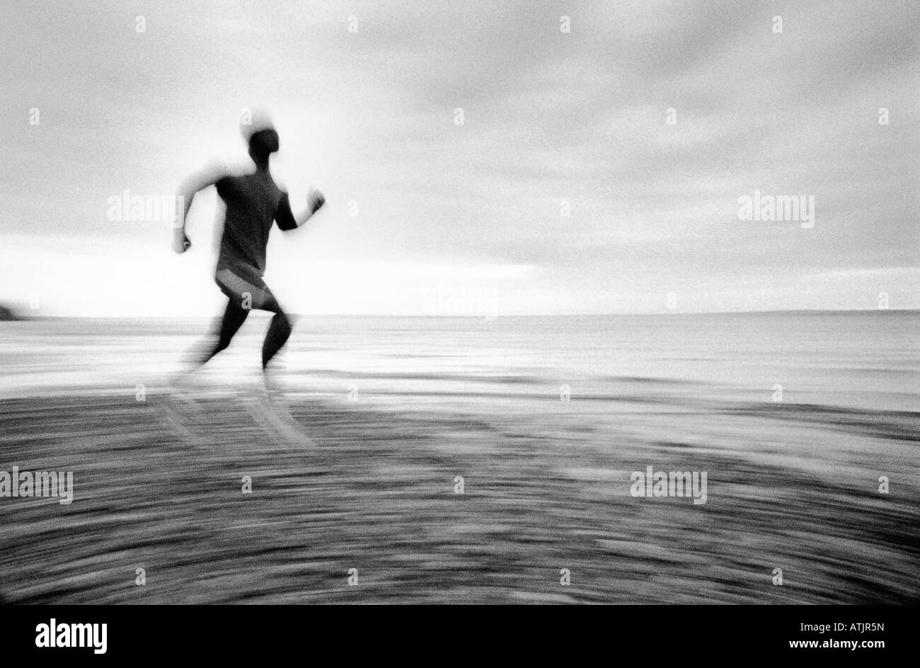 man running on beach profile distorted Stock Photo - Alamy